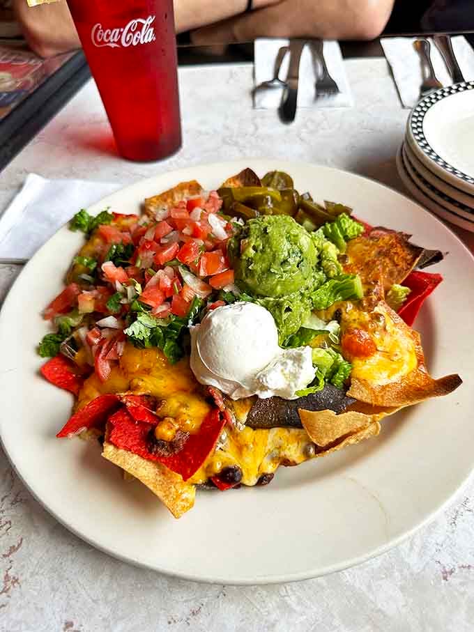 Nachos that require a strategy to eat. Every chip is a treasure map leading to guacamole gold and sour cream pearls.