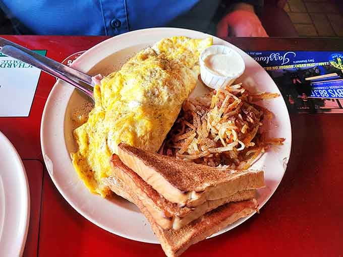 This isn't just an omelet &ndash; it's a golden envelope stuffed with morning happiness, served with a side of crispy hash browns and buttery toast.