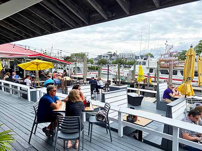 Yellow umbrellas dot the deck like maritime butterflies, sheltering happy diners as they feast with front-row seats to harbor life.