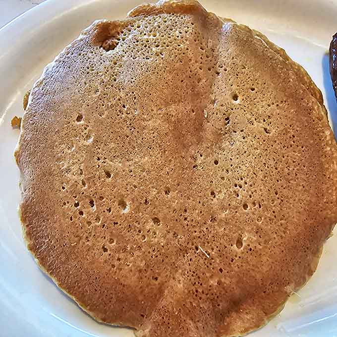 The humble pancake, elevated to art form—golden, airy, and ready to soak up maple syrup like it's been training for this moment.