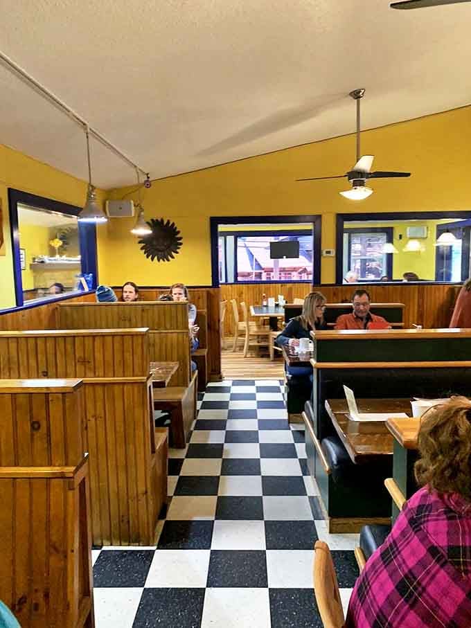 Classic diner seating with wooden booths and a checkerboard floor—where breakfast decisions are made and morning philosophies are born.