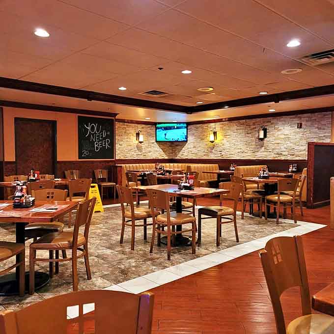 Warm lighting, stone accents, and comfortable seating create the perfect backdrop for conversations that flow as easily as the coffee refills.