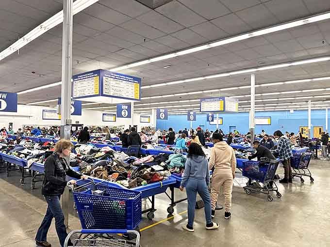 The treasure hunt in full swing! Shoppers navigate the blue bin landscape with the focus of archaeologists uncovering the next great find.