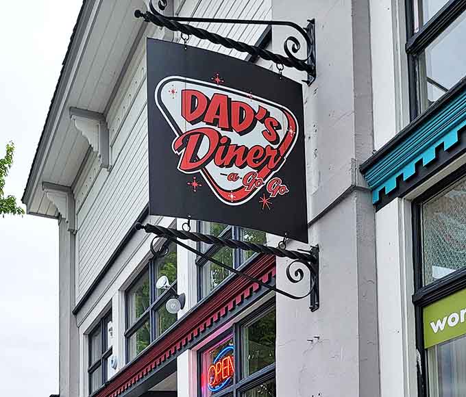 The retro-cool hanging sign announces Dad's Diner with mid-century flair, like a time machine to when diners were the original social networks.