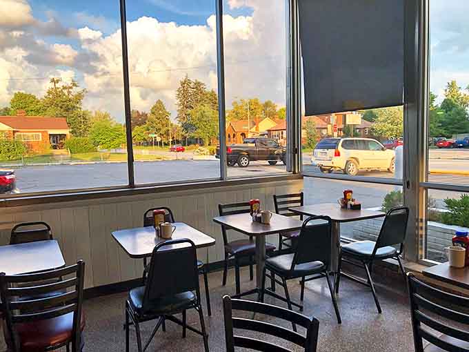 The large windows frame the neighborhood like a living postcard, letting in light while you contemplate a second slice of pie.