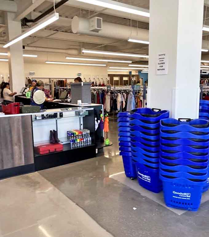 Command central for your thrifting expedition. Blue baskets stand ready for deployment as friendly staff prepare to ring up your incredible finds.