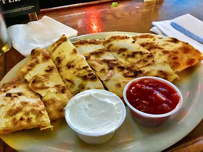 A quesadilla that takes cheese-pulling to Olympic levels. Crispy exterior, gooey interior, and dipping sauces that make each bite a new adventure.