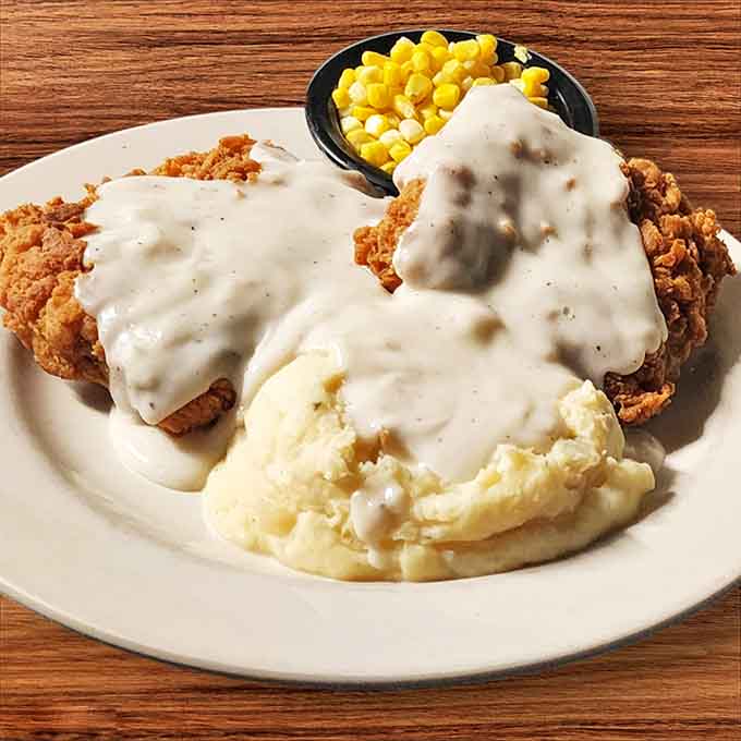 Country-fried steak swimming in peppery gravy alongside creamy mashed potatoes&mdash;comfort food that hugs you from the inside out.