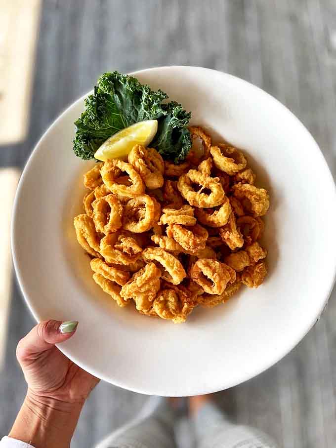 Fried calamari so tender and perfectly golden, you'll forget you're eating something with tentacles. That lemon wedge isn't just garnish&mdash;it's essential equipment.