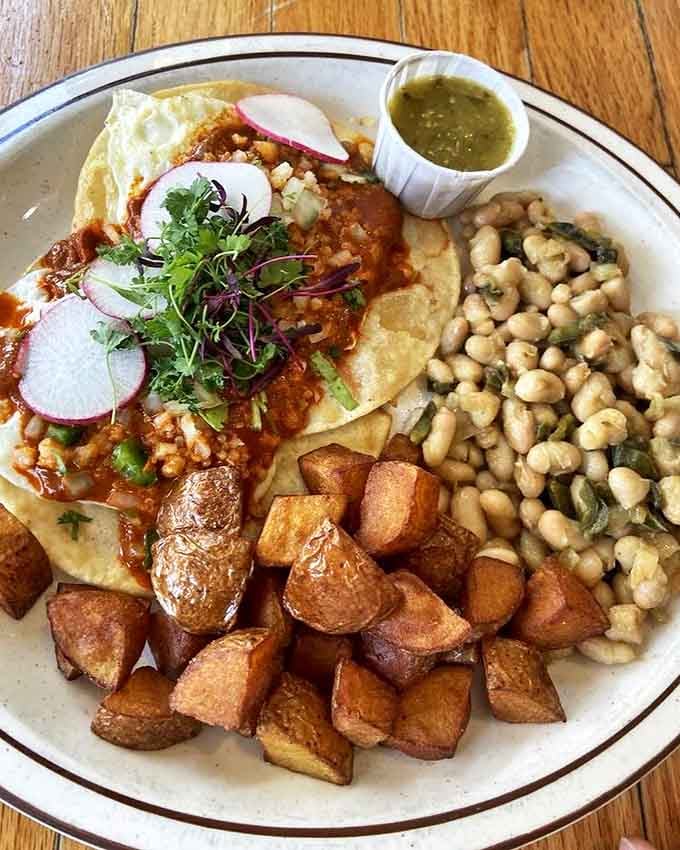 Huevos rancheros with perfectly crisp potatoes and white beans&mdash;breakfast that respects both tradition and your taste buds.