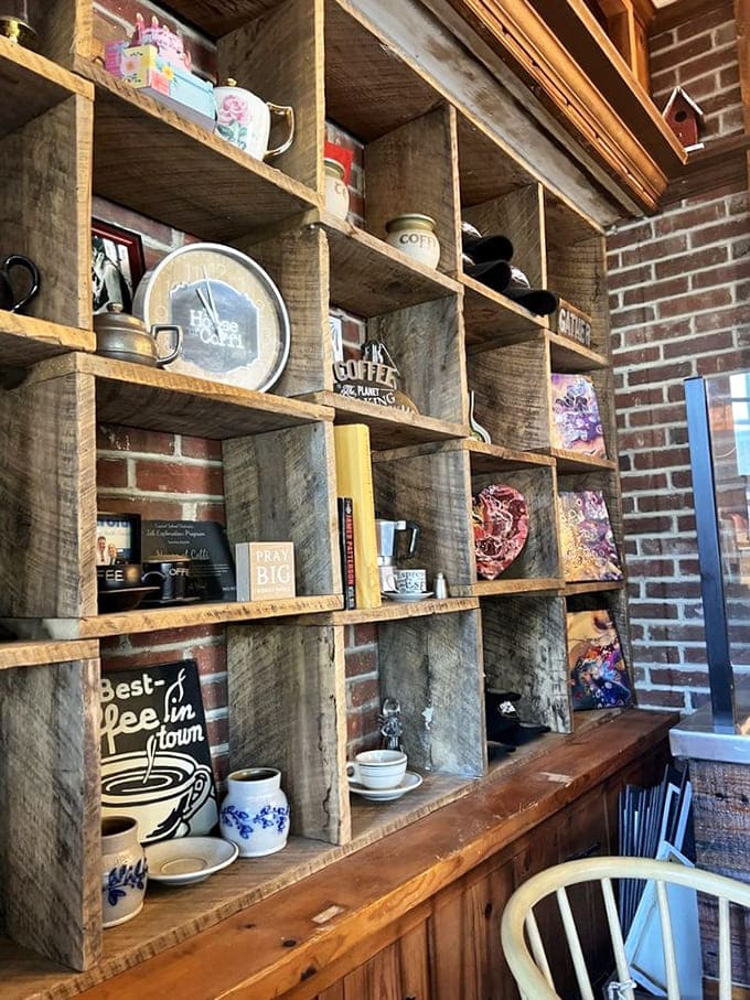 Rustic wooden shelves against exposed brick showcase coffee artifacts and local art&mdash;a museum of caffeine culture that tells stories with every carefully placed item.