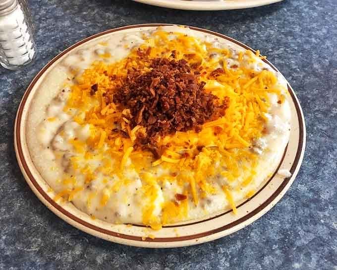 Breakfast architecture at its finest &ndash; layers of savory goodness topped with bacon crumbles and cheese that would make any morning better.