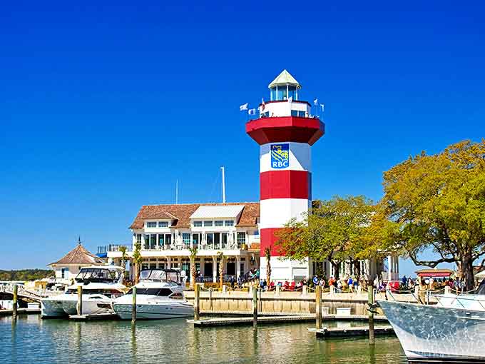 Harbour Town's iconic lighthouse stands as a candy-striped beacon of coastal charm, where boats bob in agreement that some landmarks simply never lose their magic.