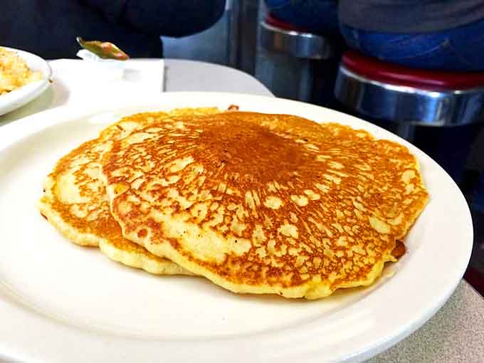 Pancakes so perfectly golden they belong in a museum. The kind that make you seriously consider ordering a second stack before finishing the first.