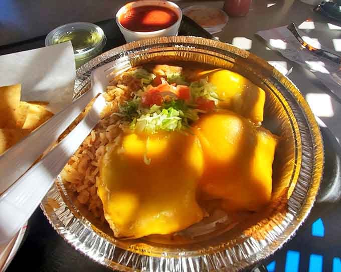 The pollo fundido doesn't just sit on the plate—it commands attention with its golden cheese cap and colorful garnish. This is chicken living its best life.