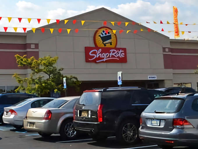 ShopRite's colorful pennants flutter in the breeze, welcoming shoppers to this essential community hub where neighbors inevitably run into each other.