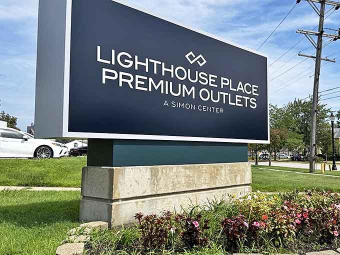 The sleek modern sign welcomes visitors to what locals know is less a shopping center and more a financial strategy disguised as recreation.