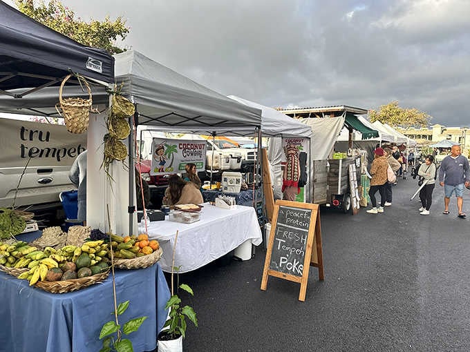 Upcountry Farmers Market buzzes with local energy as vendors showcase the bounty of Maui's fertile volcanic soil under tents and canopies.