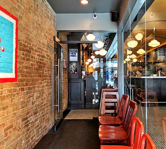 The waiting area feels less like a holding pattern and more like the prelude to something wonderful&mdash;brick walls whispering promises of deliciousness to come.