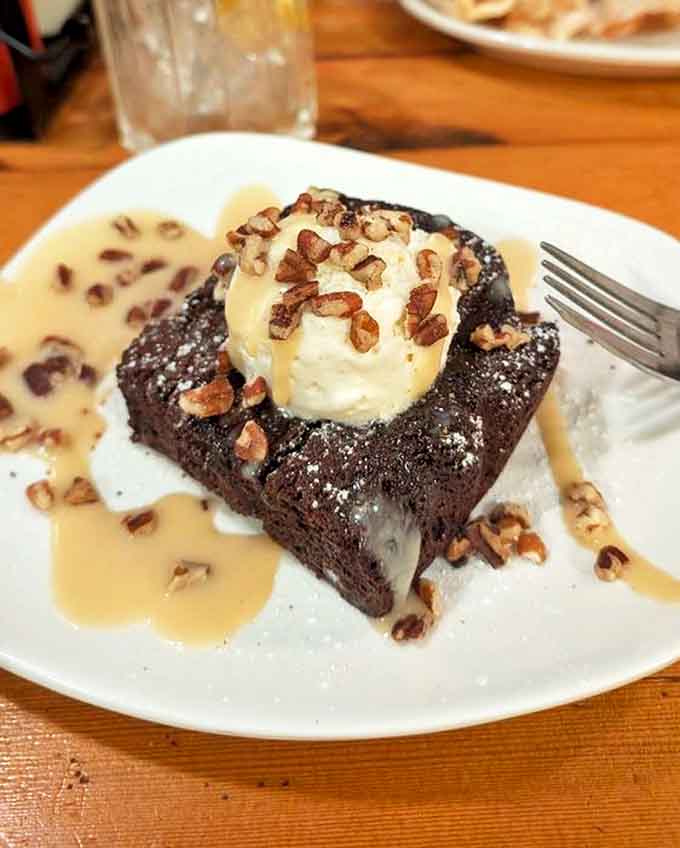 This warm brownie with ice cream and pecans isn't just dessert &ndash; it's the grand finale that somehow finds room even after you've sworn you couldn't eat another bite.