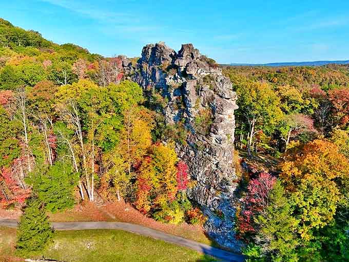 Chimney Rock stands tall amid autumn's paintbox, a natural skyscraper surrounded by a sea of fall foliage.