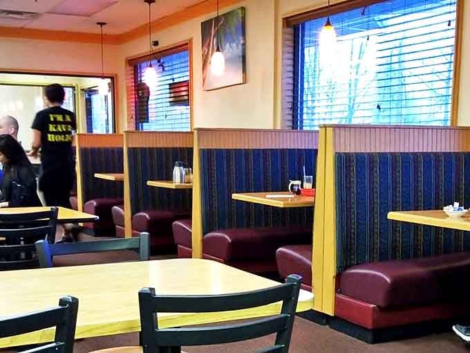 Blue-striped booths create semi-private breakfast sanctuaries &ndash; perfect for recovery conversations after long Alaskan nights.