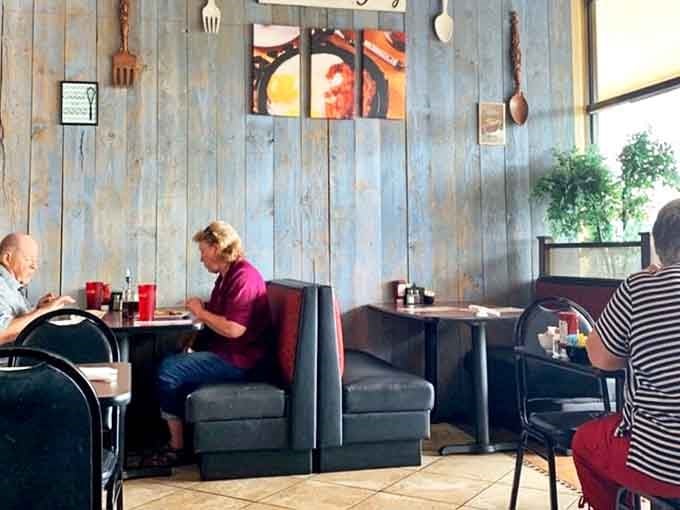 The booths offer that perfect balance of privacy and people-watching, with blue paneling that somehow makes everything taste better.
