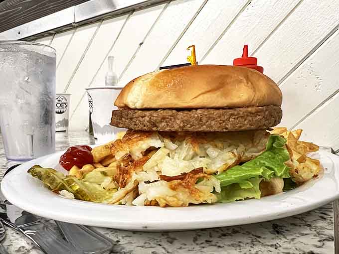 A burger that requires both hands, proper structural engineering, and possibly a post-meal nap. That bun is load-bearing architecture at its finest.