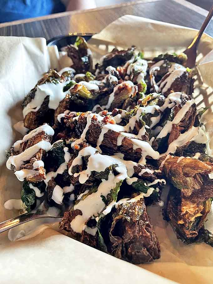 Brussels sprouts that could convert the most dedicated vegetable skeptic &ndash; crispy, drizzled with creamy sauce, and absolutely impossible to share.