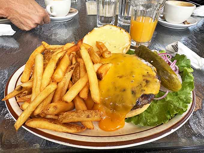 This isn't just a burger &ndash; it's a towering testament to beef's finest hour, complete with golden fries standing at attention.