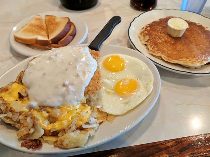 Breakfast of champions: country-fried potatoes smothered in gravy, sunny-side-up eggs, and pancakes that could convert a breakfast skeptic.
