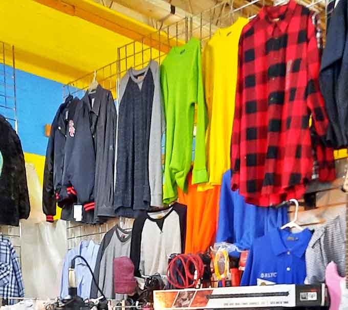 A rainbow of garments hanging like colorful promises. That buffalo plaid shirt is practically screaming "Michigan winter approved!"