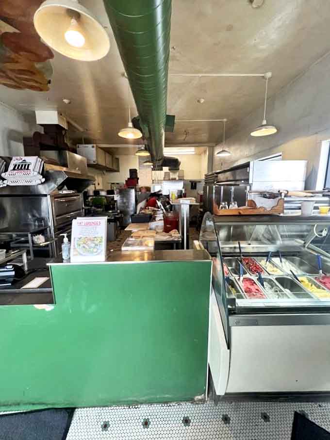 The open kitchen&mdash;where pizza magic happens in full view. No secrets, no pretense, just the hypnotic rhythm of dough being transformed into dreams.