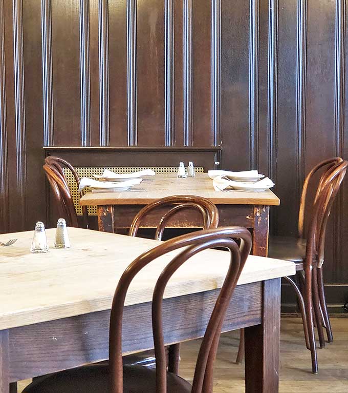 Dark wood paneling and simple place settings – because when the steak is this good, nothing else needs to compete for attention.