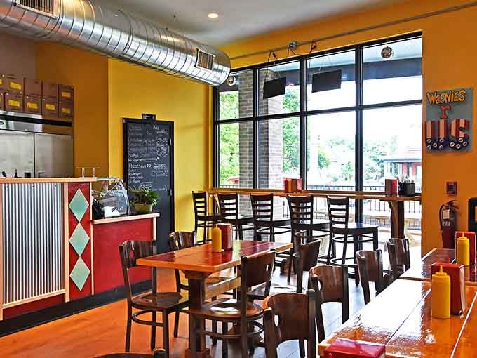 Bright yellow walls, wooden tables, and an open kitchen create a space that feels like summer regardless of the season outside.
