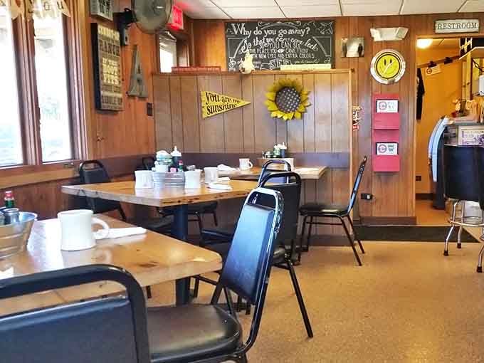 Empty tables that won't stay that way for long. The sunflower on the wall isn't the only thing bringing warmth to this cozy space.