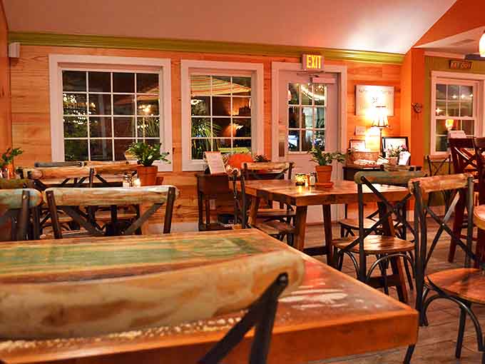 Evening transforms the dining room into a warm, golden sanctuary. Those wooden tables have heard more food epiphanies than a cooking show confession booth.
