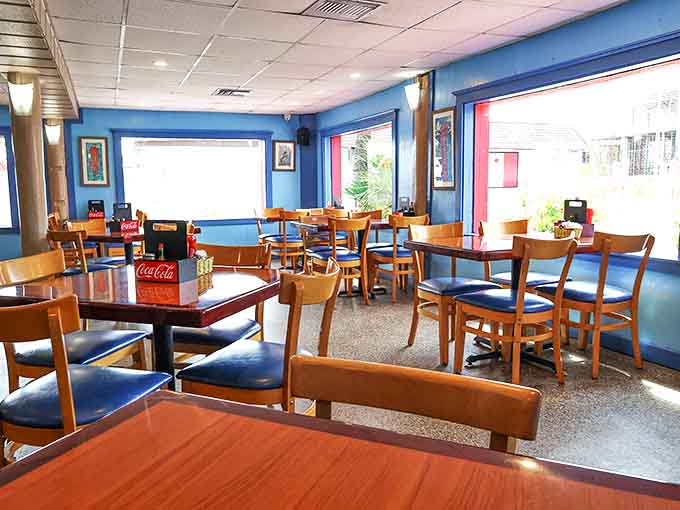 Sun streams through windows illuminating wooden tables where countless "best meal of our vacation" memories have been made.