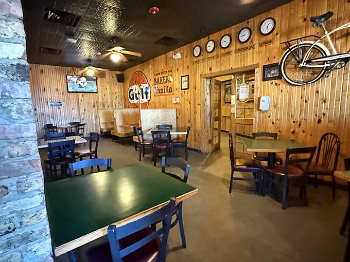 Wooden walls, green tables, and mismatched chairs create that perfect "third place" where comfort trumps design and conversations flow as freely as the drinks.