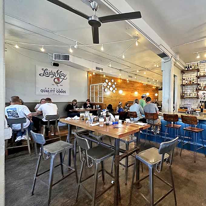 Communal tables and industrial stools create a space where strangers become friends over shared plates and second rounds.