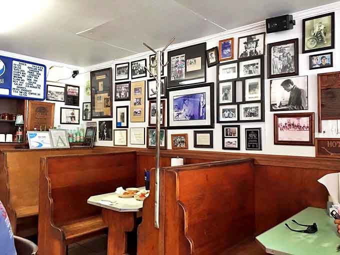 Every photo on these walls tells a story. The wooden booths have absorbed decades of laughter, tears, and the occasional spilled milkshake.