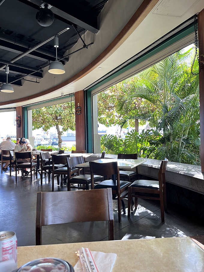 Window seating that frames nature's artwork. Half the flavor comes from watching boats bob while palm fronds dance in the breeze.