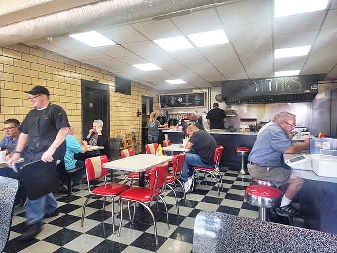 A slice of Americana where strangers become neighbors. Red chairs and shared food stories—this is community in its purest form.