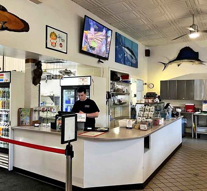 Where the magic happens &ndash; staff working behind the counter with the focus of seafood surgeons.