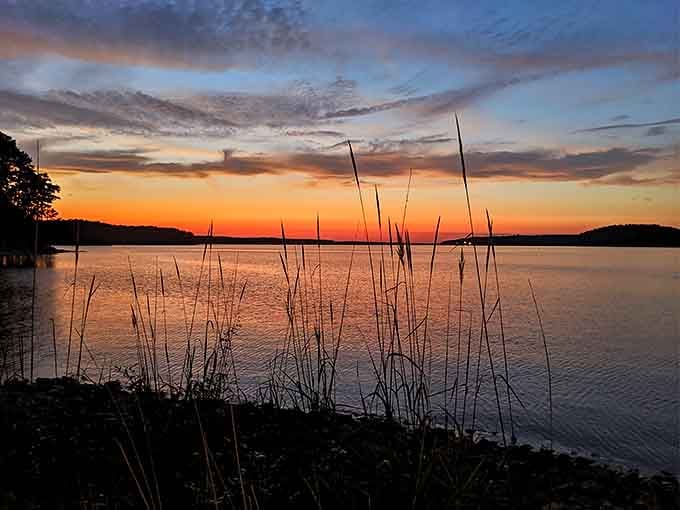 Sunset paints the lake in impossible colors, creating the kind of moment that makes amateur photographers look like professionals.