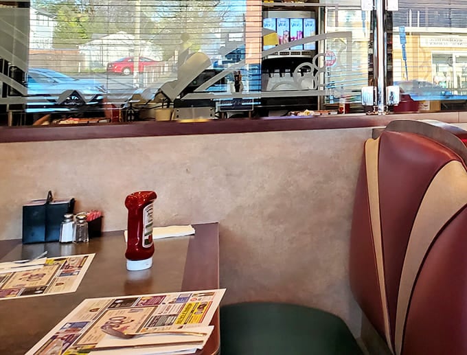Every proper booth needs its holy trinity: ketchup, napkin dispenser, and local paper. The stage is set for the time-honored tradition of booth philosophy.