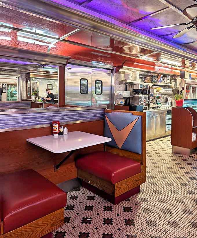 Red vinyl meets chrome in this booth sanctuary—where coffee refills are frequent and the ketchup bottle is always within reach.