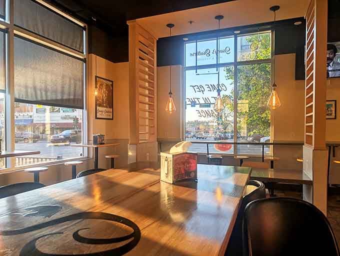 Natural light bathes wooden tables where BBQ memories are made. Not just a meal, but a moment worth capturing before the first bite.