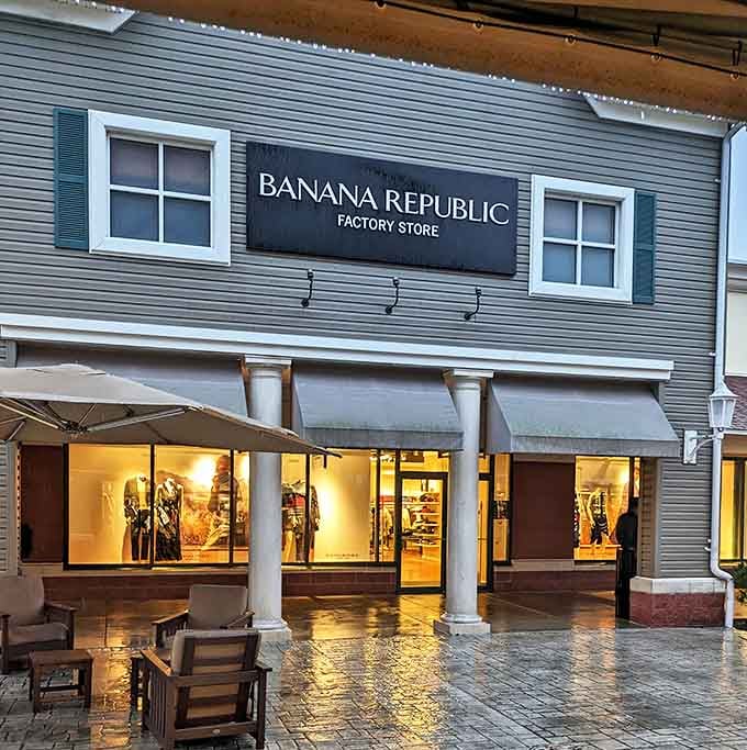 Banana Republic's evening glow creates an almost magical shopping atmosphere. Those Adirondack chairs outside aren't just seating&mdash;they're relationship-saving rest stops for weary shopping companions.