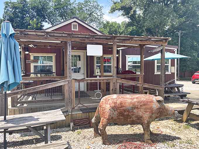 This rustic porch and wooden pig statue announce without subtlety: serious BBQ happens here, and diet plans come to die.
